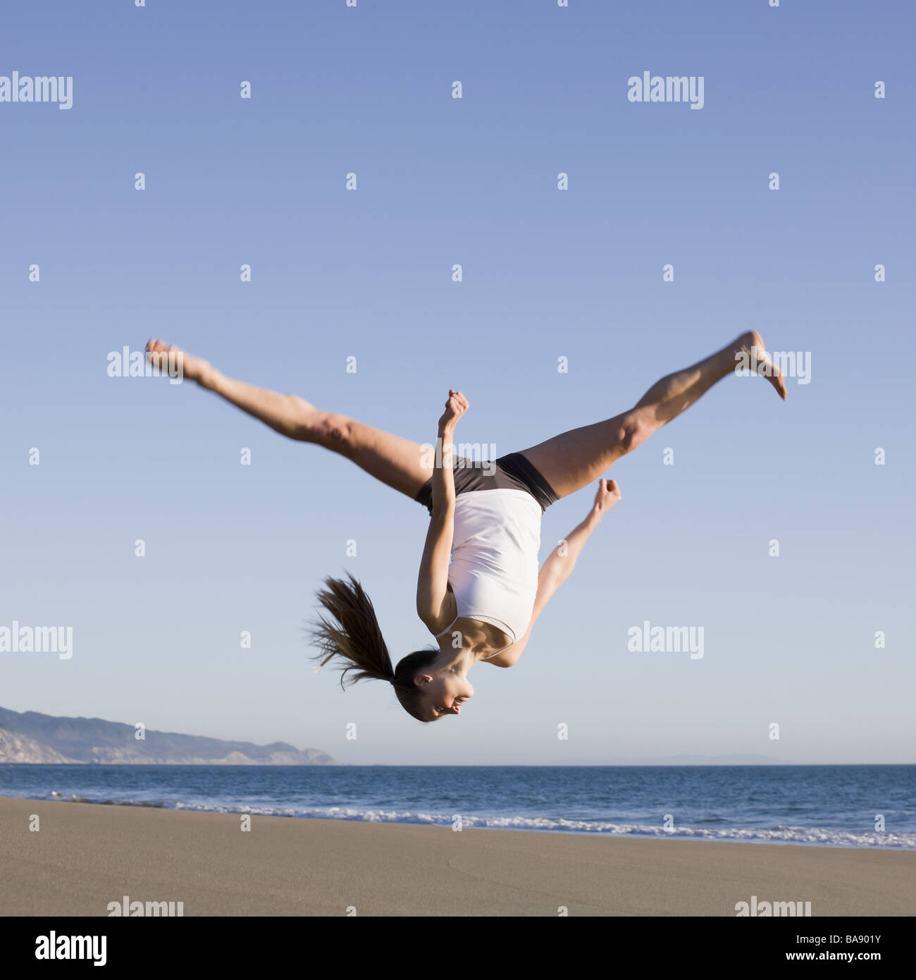 Woman jumping on beach Stock Photo - Alamy