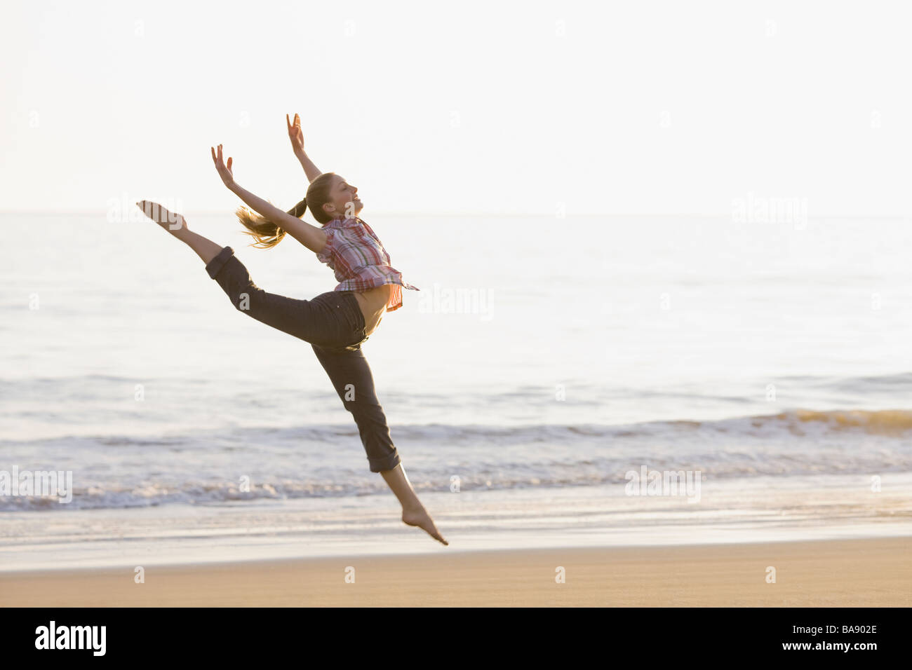 Woman dancing on beach Stock Photo - Alamy