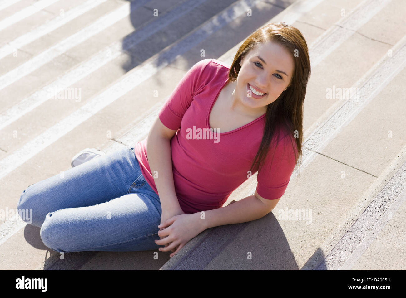 Teenage girl sitting on steps Stock Photo - Alamy