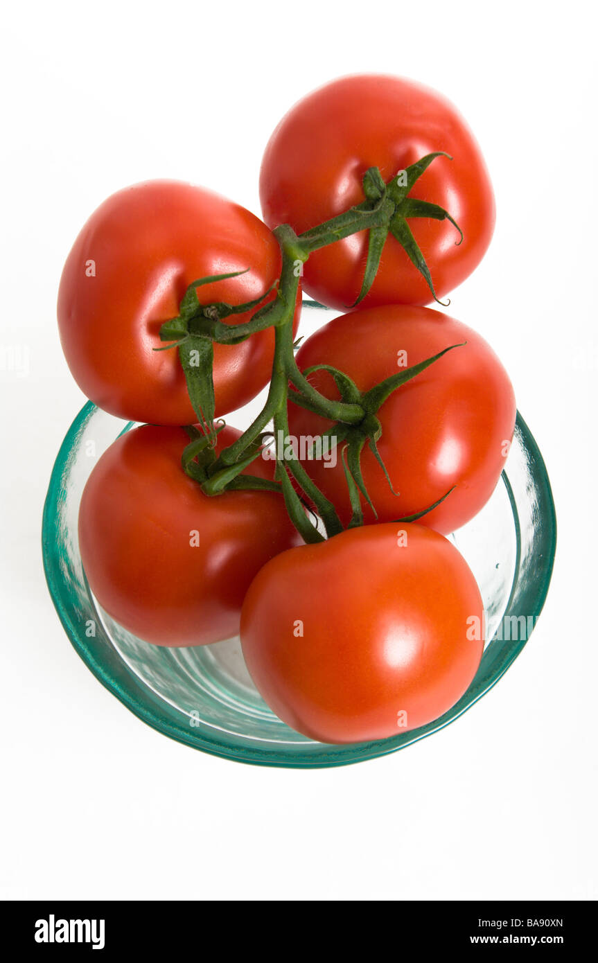 five tomatoes in a glass bowl Stock Photo - Alamy