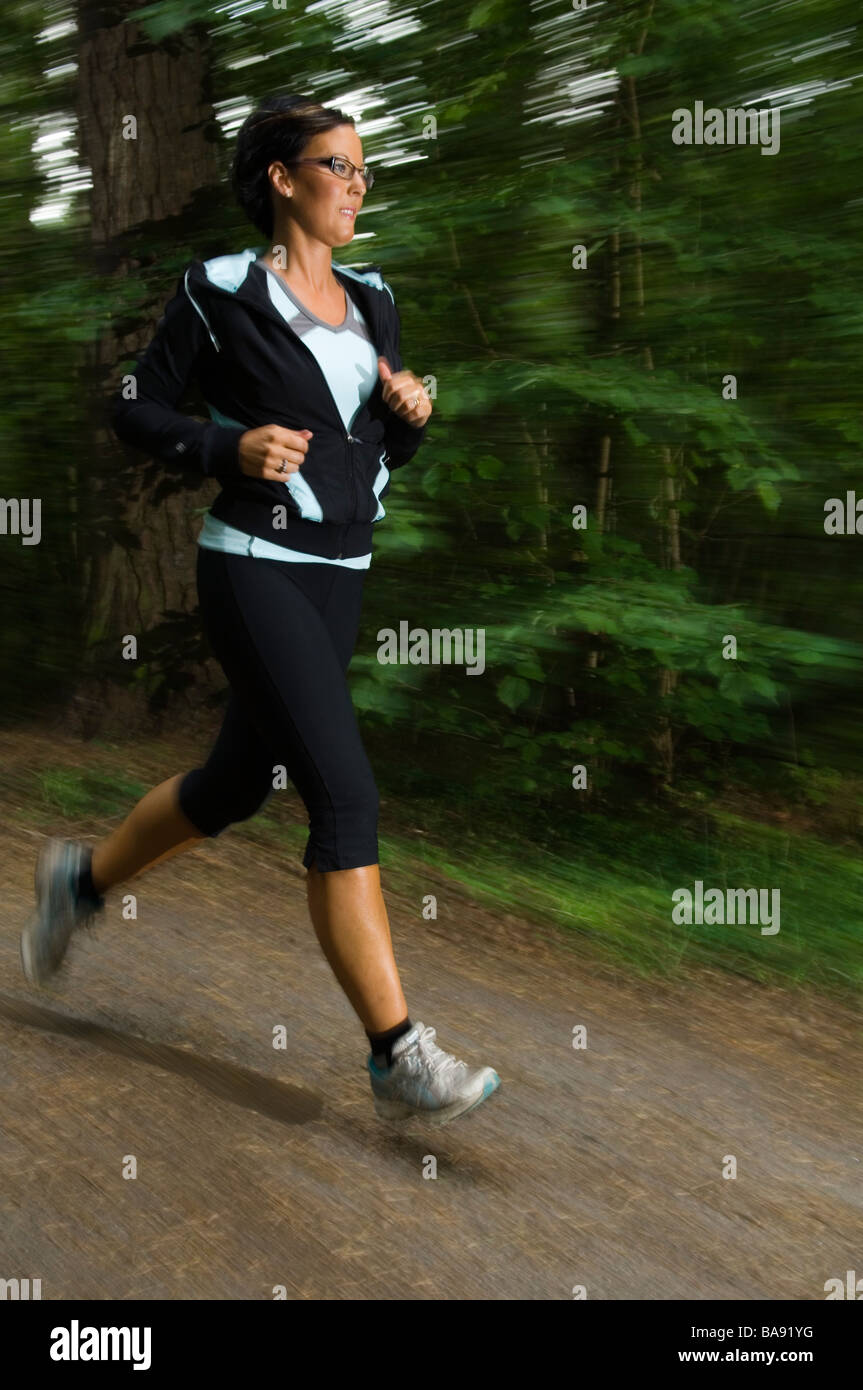 A woman yogging in a forest Sweden Stock Photo - Alamy