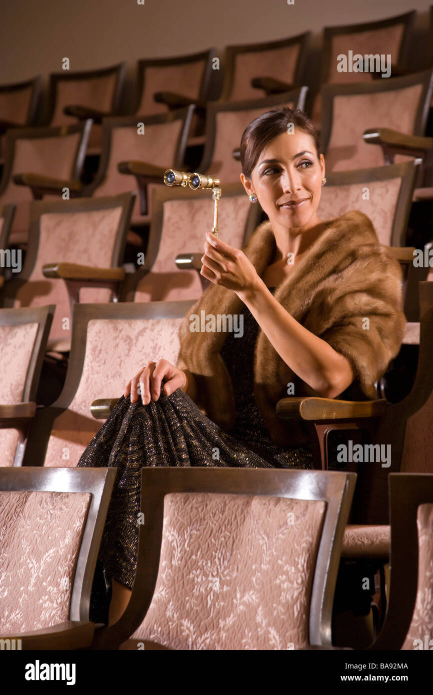 Hispanic woman in formal gown sitting in theater Stock Photo - Alamy