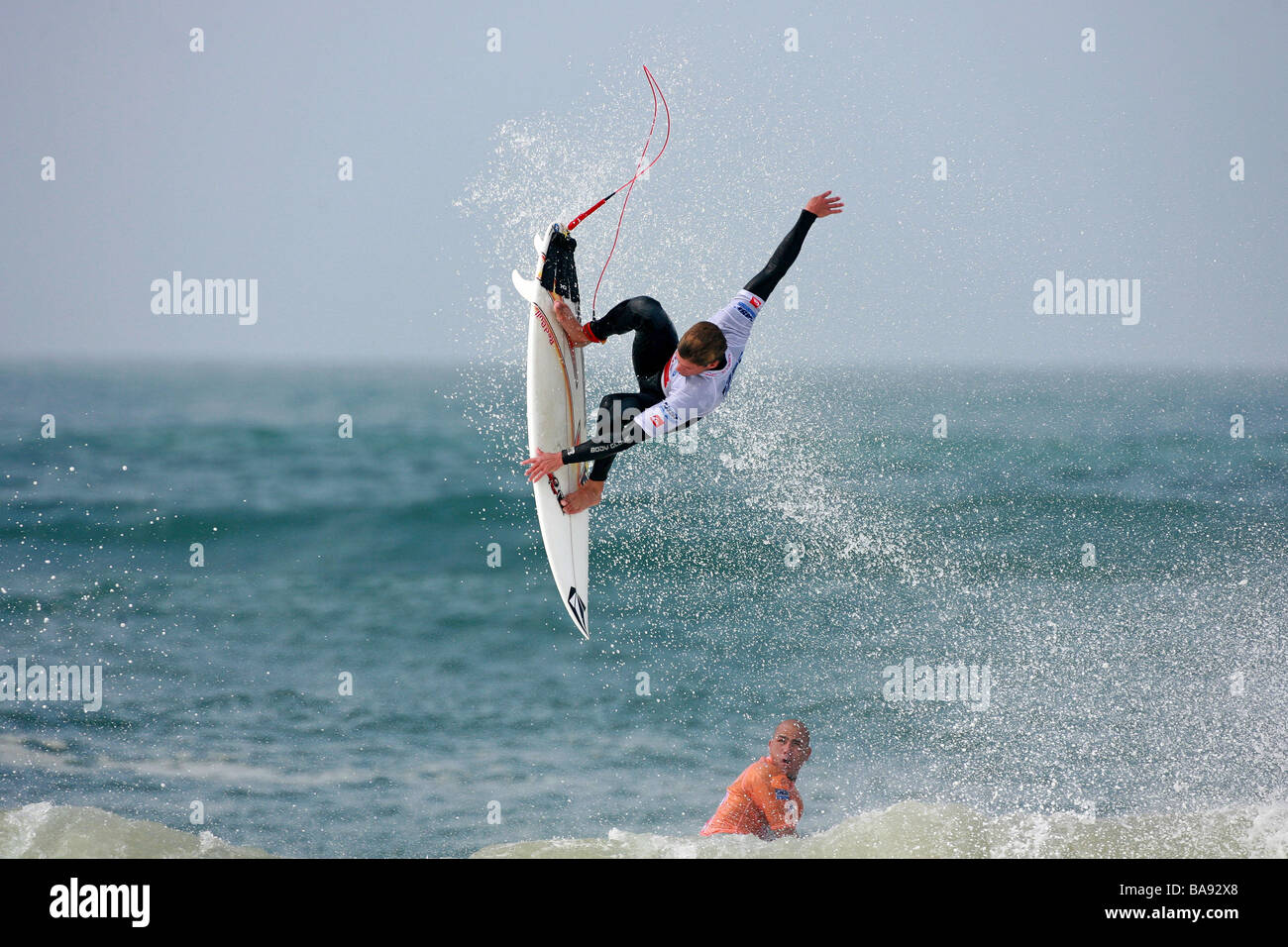 Surfer perfoming a Jump of a Wave Stock Photo - Alamy