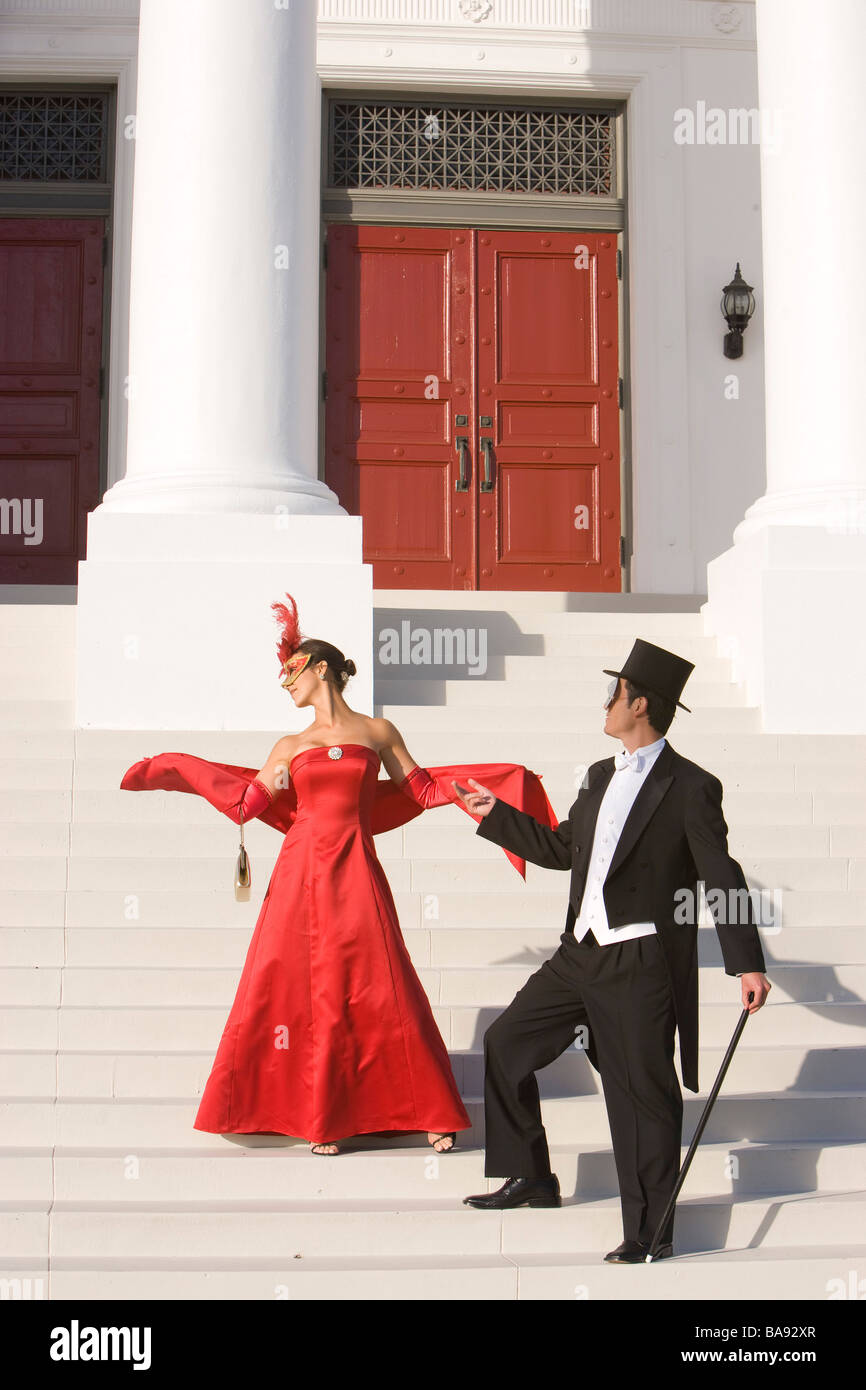 Couple in masquerade costumes standing outside theater Stock Photo - Alamy