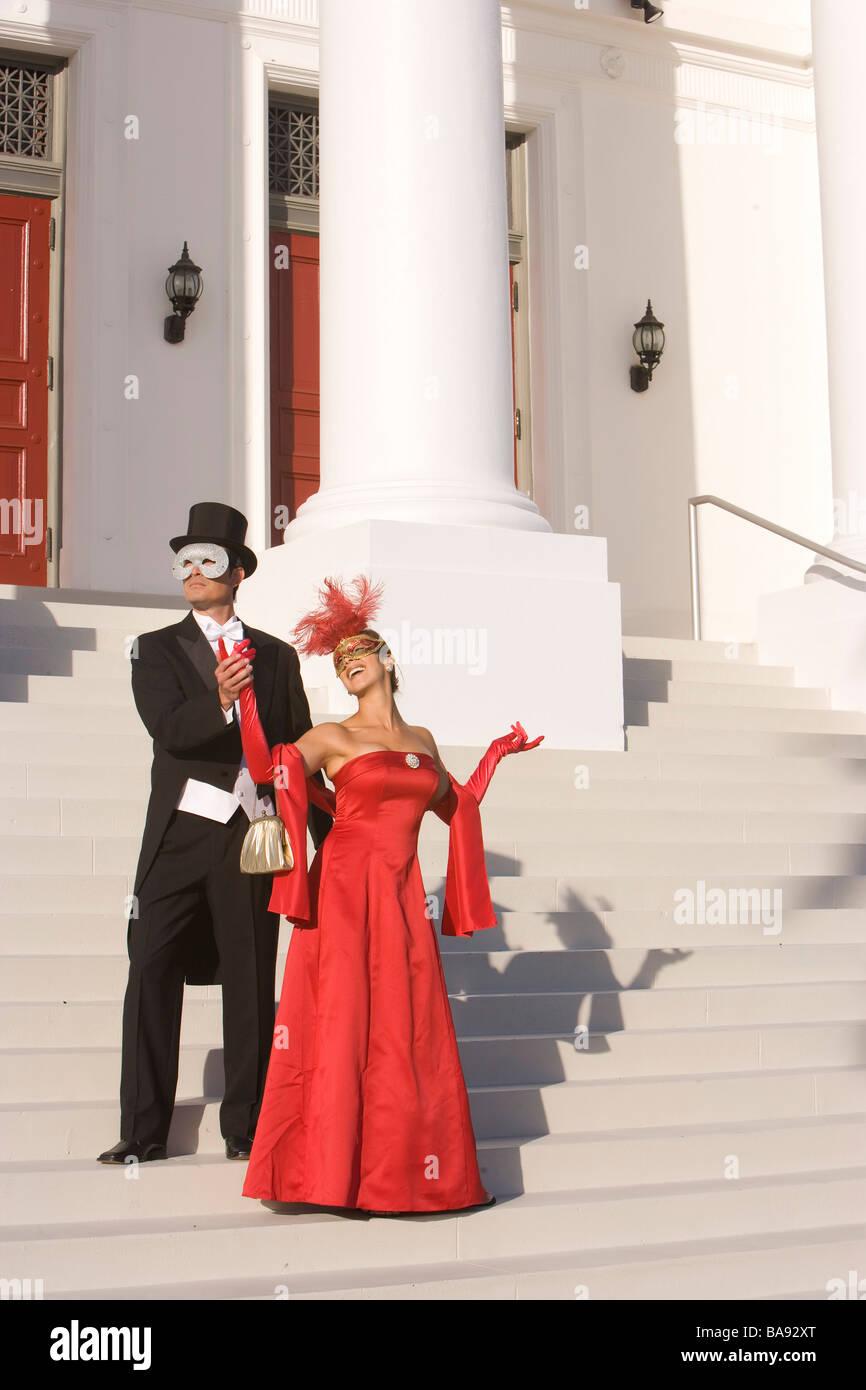 Couple in masquerade costumes standing outside theater Stock Photo - Alamy
