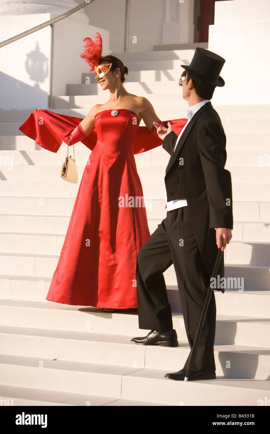 Couple in masquerade costumes standing outside theater Stock Photo - Alamy