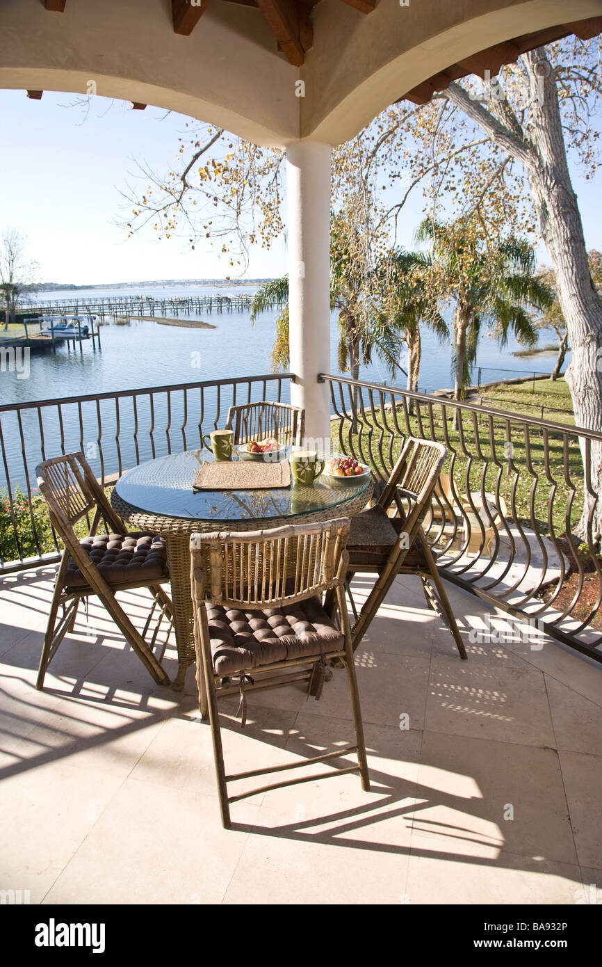 Table and chairs on balcony of house Stock Photo - Alamy