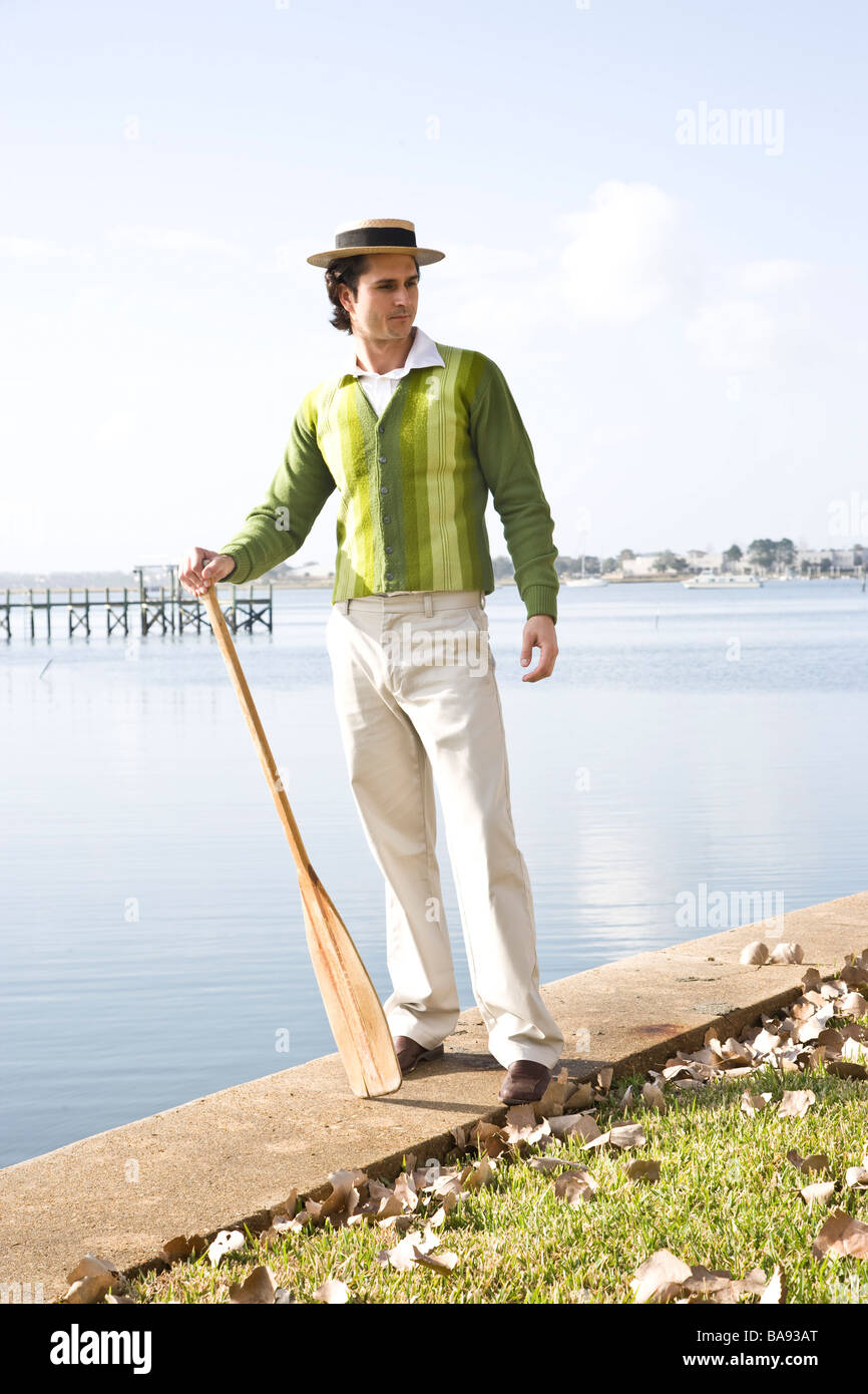 Portrait of 1920s socialite man with oar standing by water Stock Photo ...