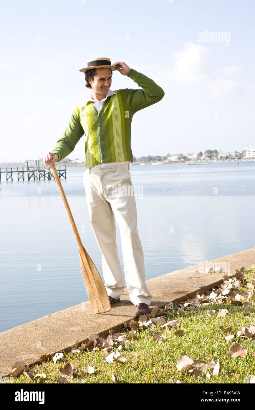 Portrait of 1920s socialite man with oar standing by water Stock Photo ...