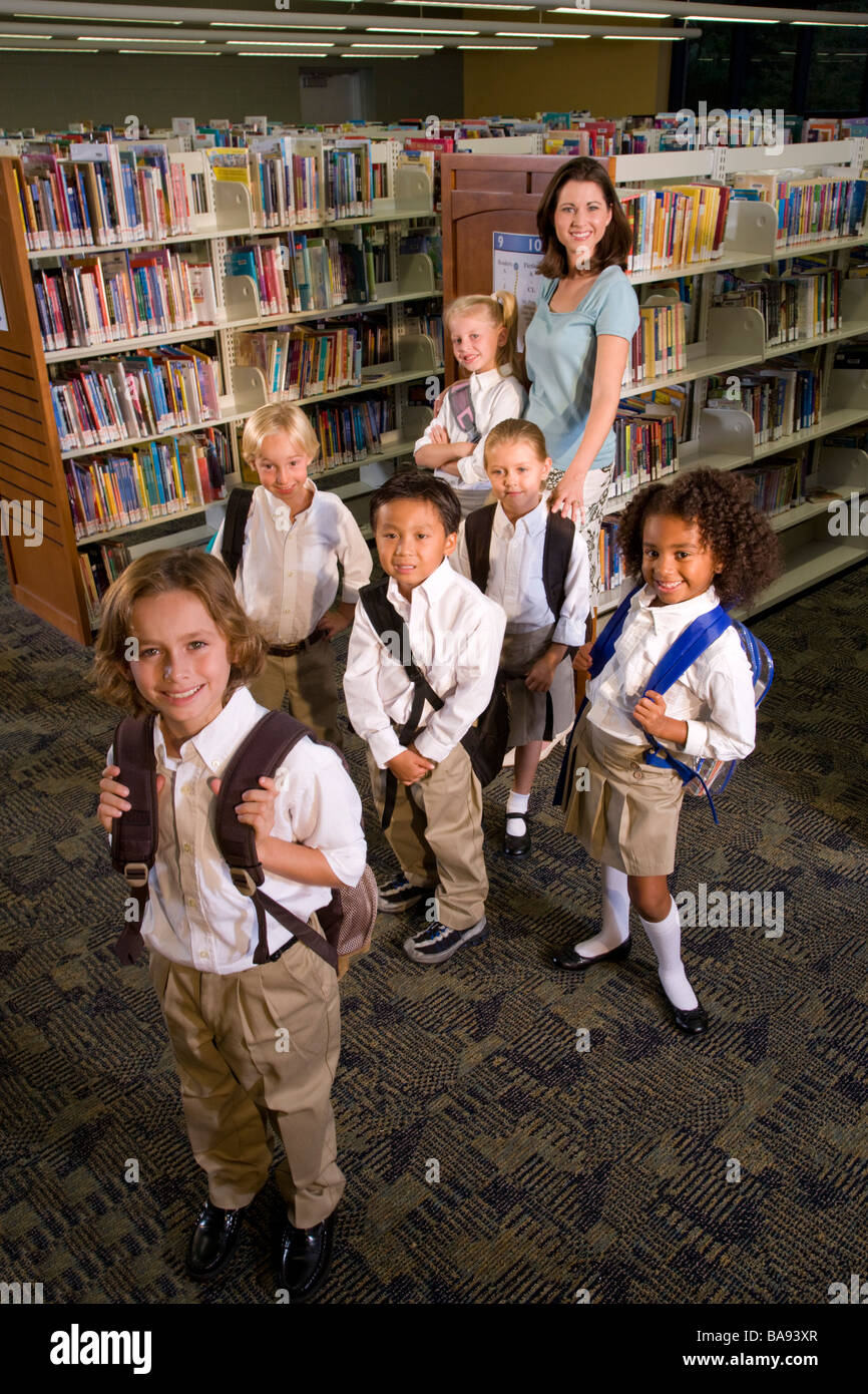 Portrait of elementary school teacher with pupils in library Stock ...