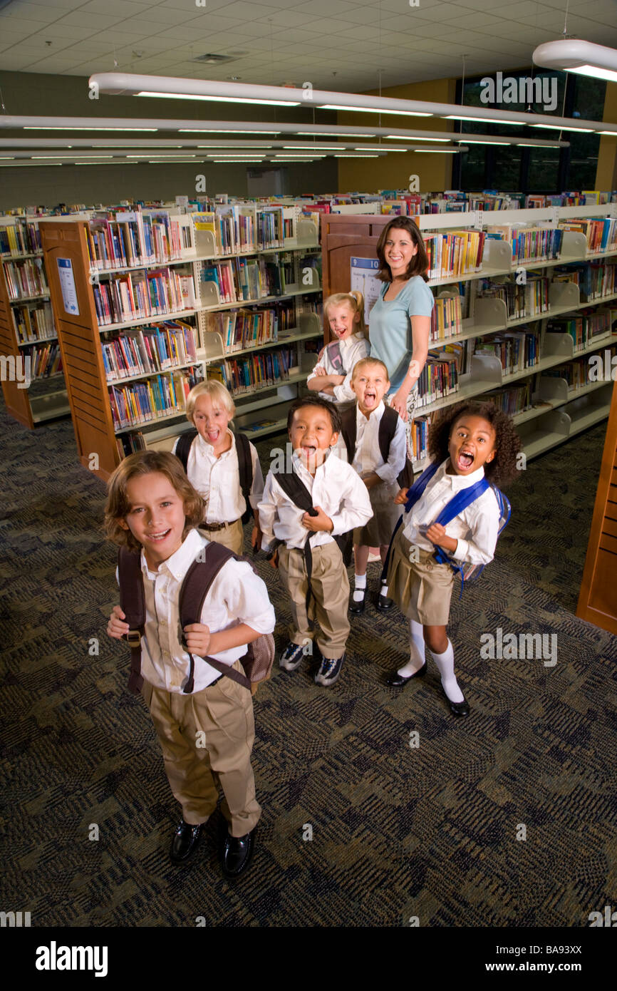 Portrait of elementary school teacher with pupils in library Stock ...