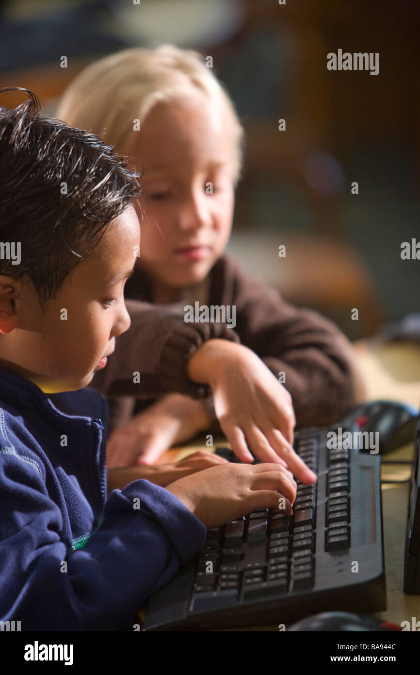 Two elementary school boys using computer Stock Photo - Alamy