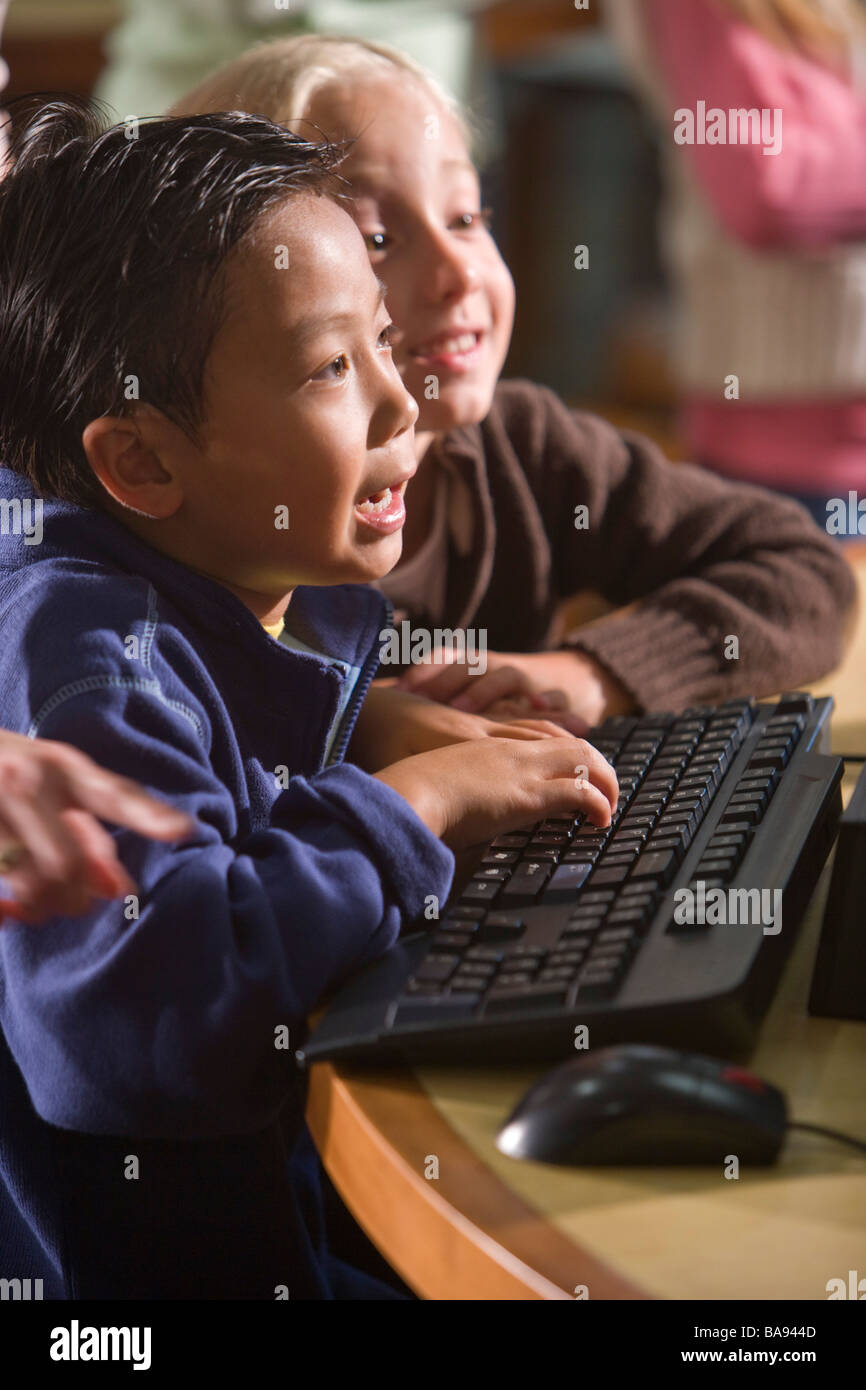 Two elementary school boys using computer Stock Photo - Alamy