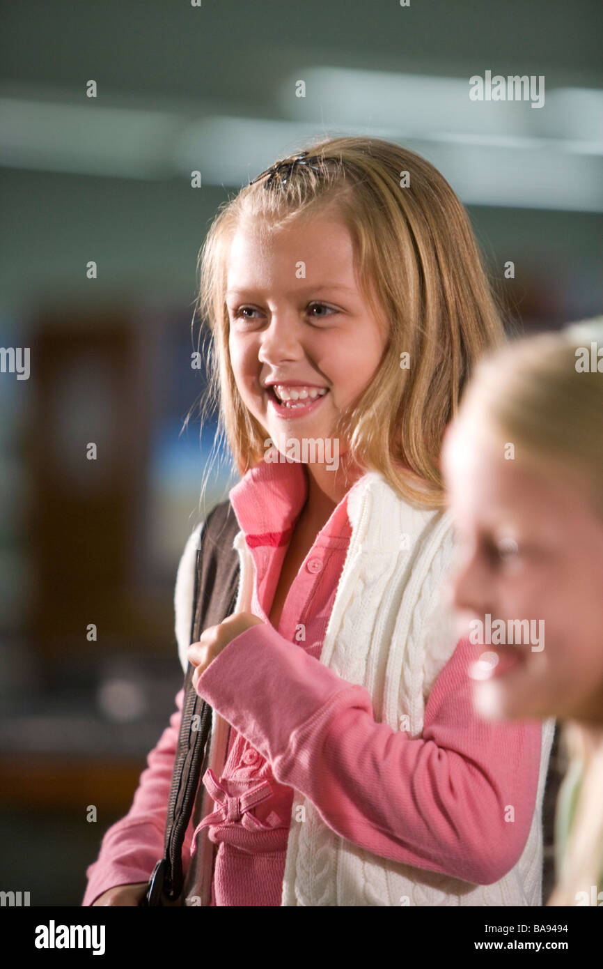 Elementary school girls smiling in library Stock Photo - Alamy