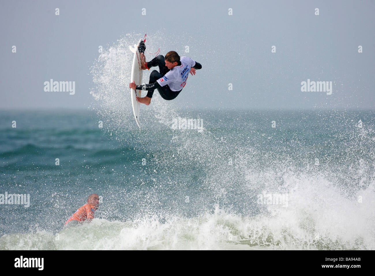 Surfer perfoming a Jump of a Wave Stock Photo - Alamy