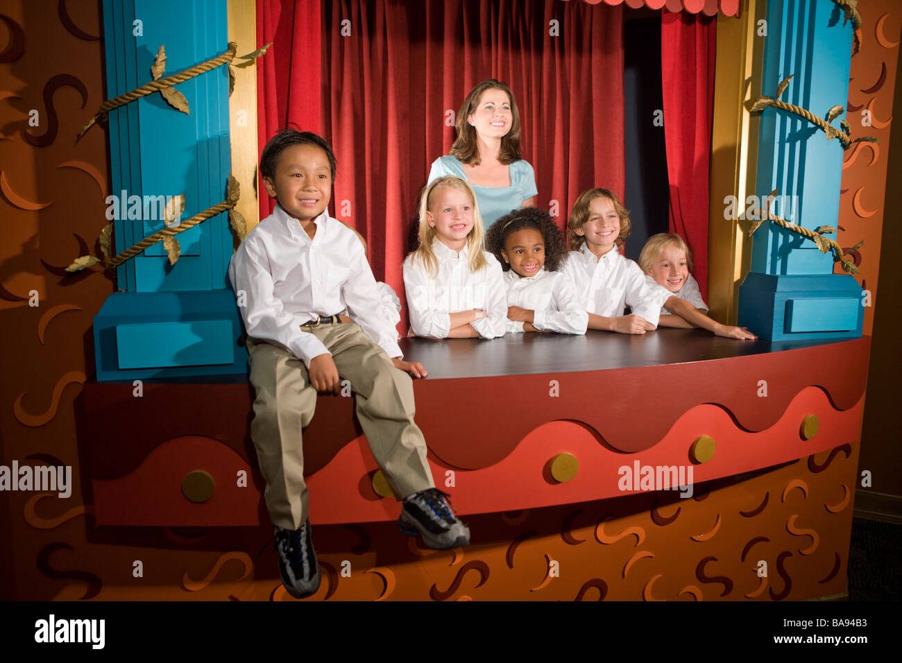 Elementary school teacher and pupils in puppet theatre Stock Photo - Alamy