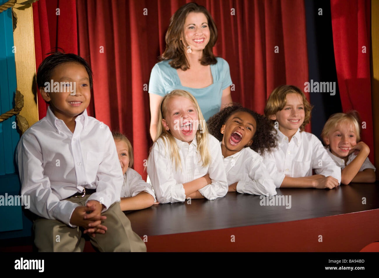 Elementary school teacher and pupils in puppet theatre Stock Photo - Alamy