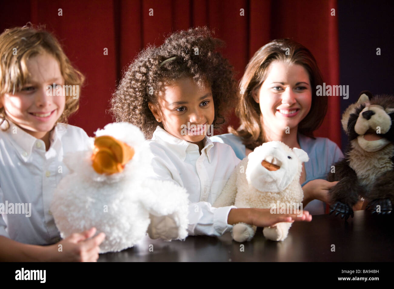 Elementary school teacher and pupils performing in puppet theatre Stock ...