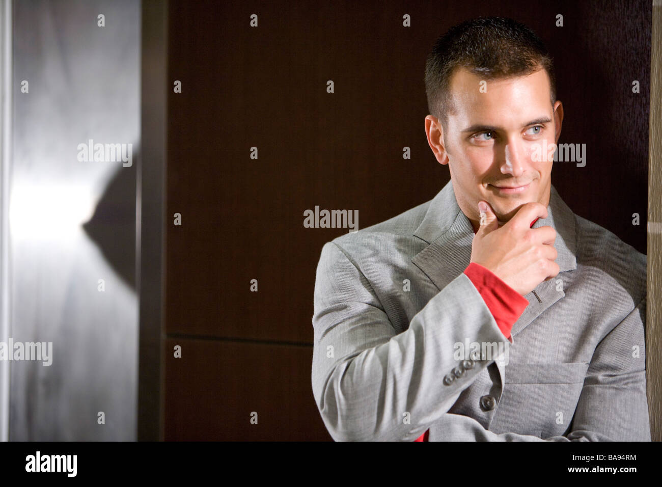 Headshot of young businessman thinking Stock Photo - Alamy