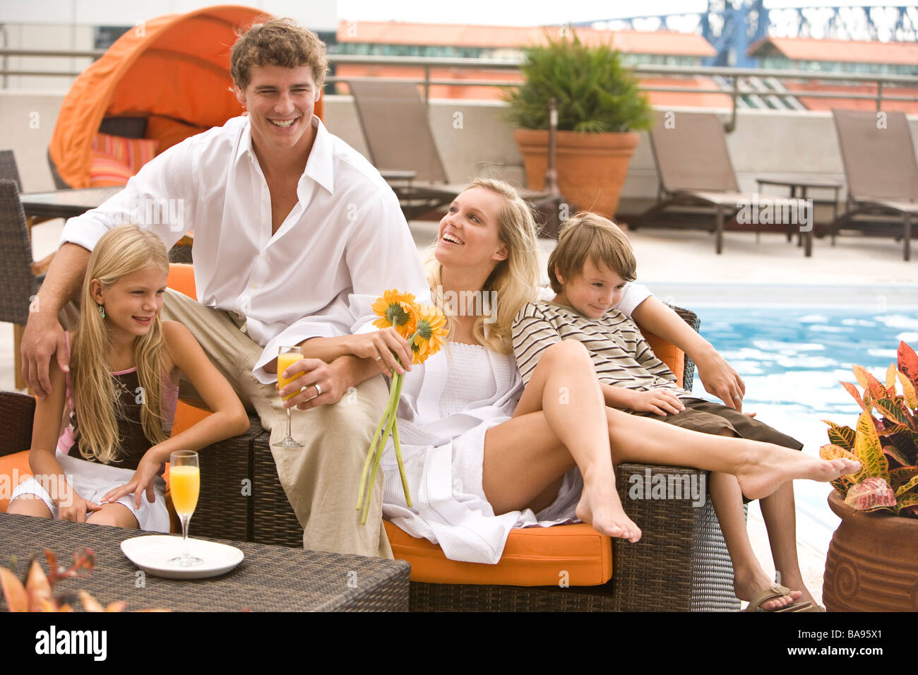 Family lounging poolside on rooftop hi-res stock photography and images ...