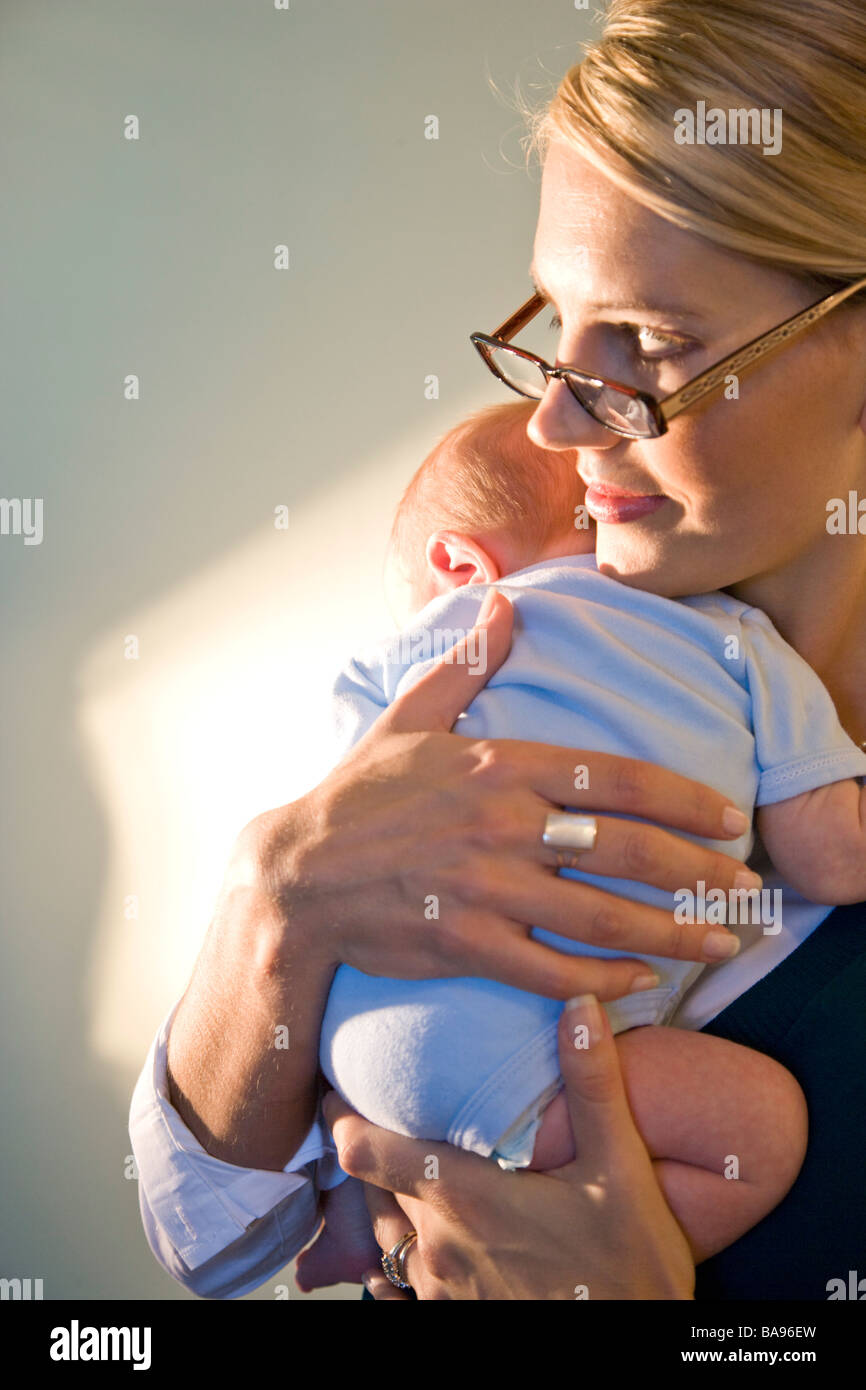 Close-up of mom gently hugging baby Stock Photo - Alamy