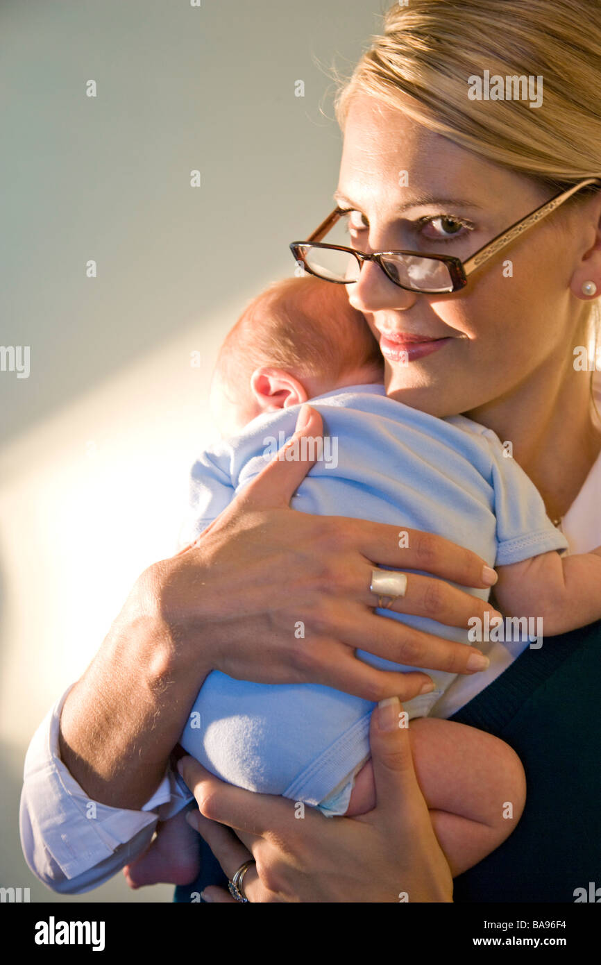 Close-up of mom gently hugging baby Stock Photo - Alamy