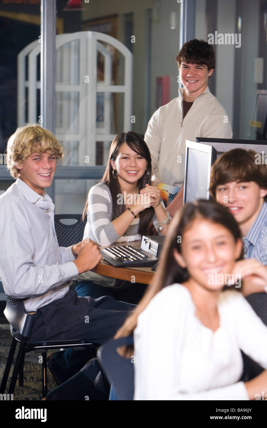 Portrait of teenage students using computers in library Stock Photo - Alamy
