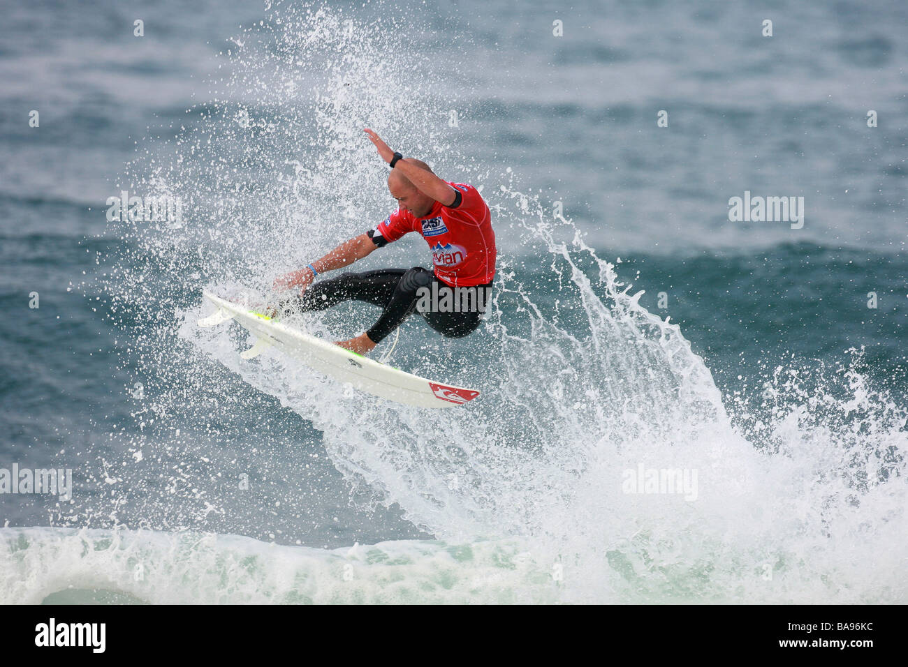 Surfer perfoming a Jump of a Wave Stock Photo - Alamy
