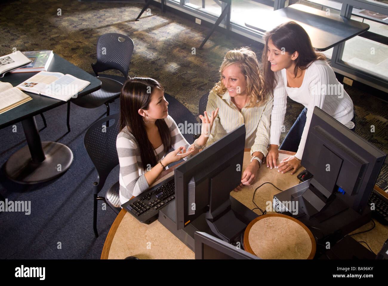 Teenage students sitting at computers in library Stock Photo - Alamy