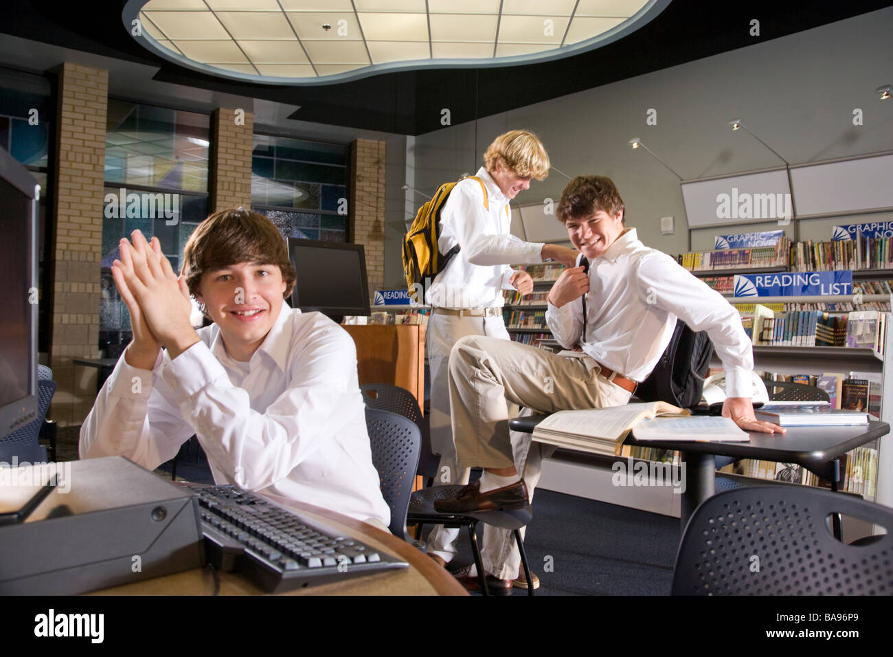Portrait of teenage student boys in library Stock Photo - Alamy