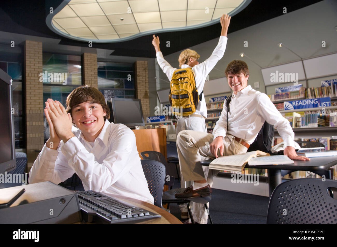 Portrait of teenage student boys in library Stock Photo - Alamy