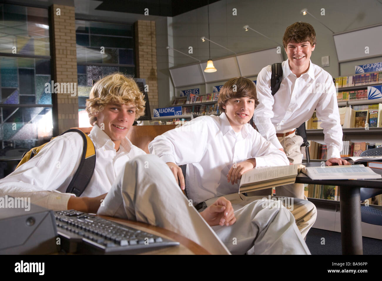 Portrait of teenage student boys in library Stock Photo - Alamy