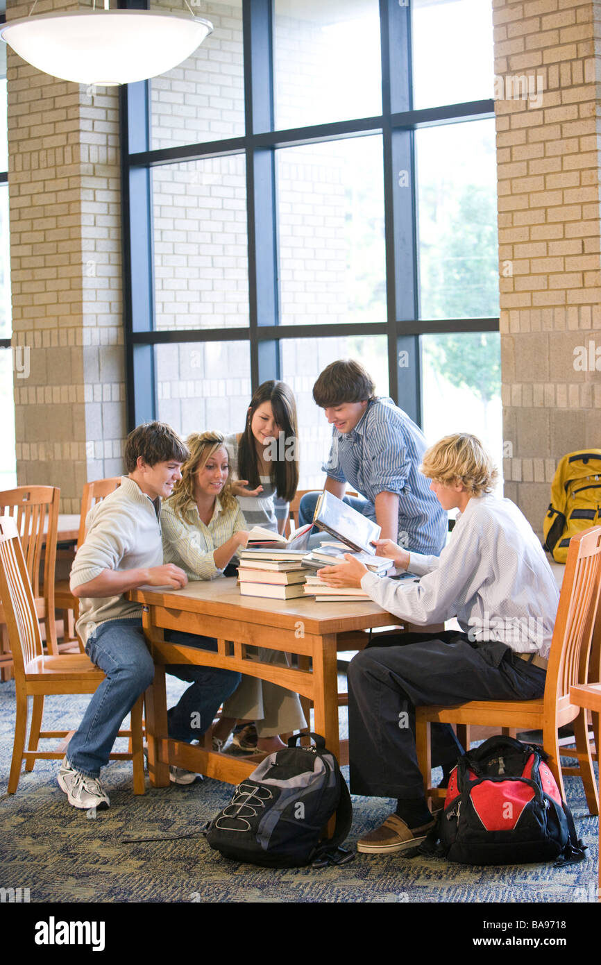 Teenage students studying in library Stock Photo - Alamy