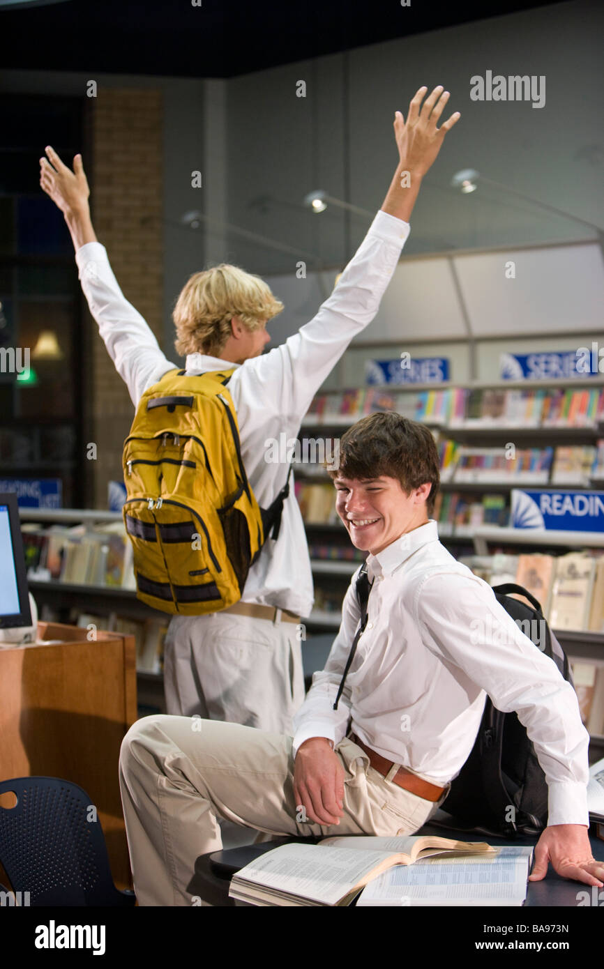 Two high school students having fun in library Stock Photo - Alamy