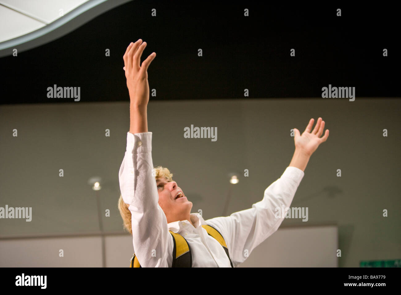 Teenage high school student with arms raised Stock Photo - Alamy
