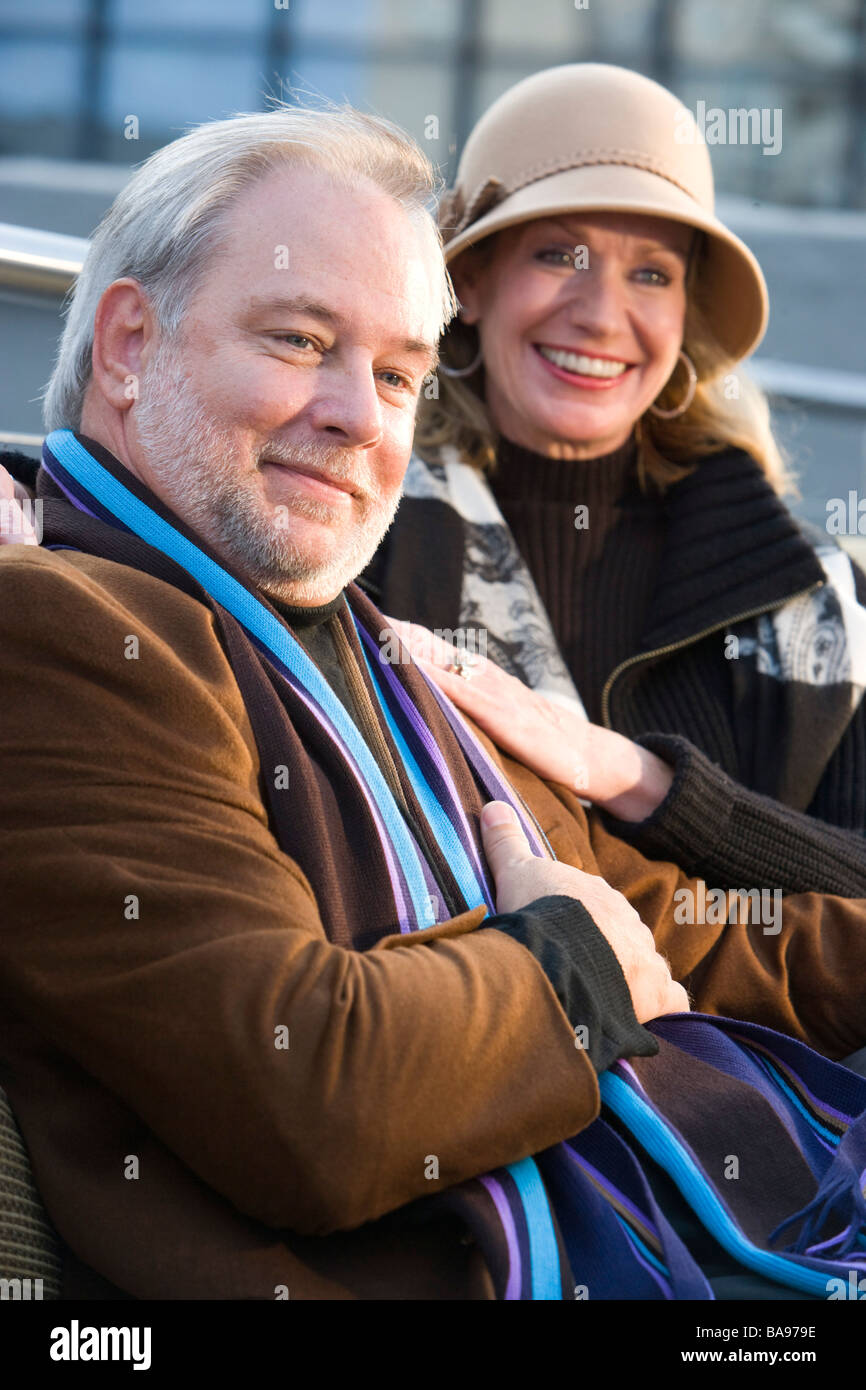 Middle-aged couple relaxing on rooftop of modern downtown loft Stock ...