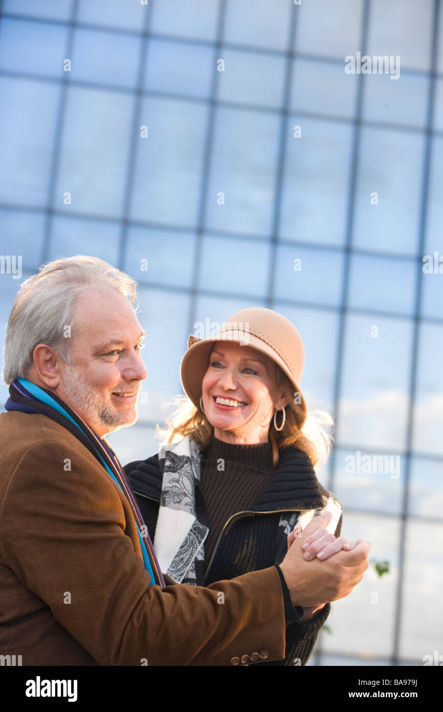 Middle-aged couple dancing on rooftop of modern downtown loft Stock ...