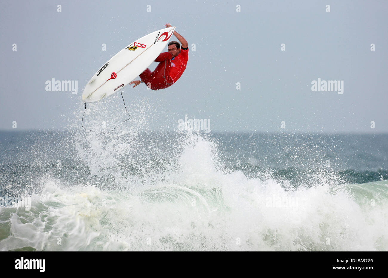 Surfer perfoming a Jump of a Wave Stock Photo - Alamy