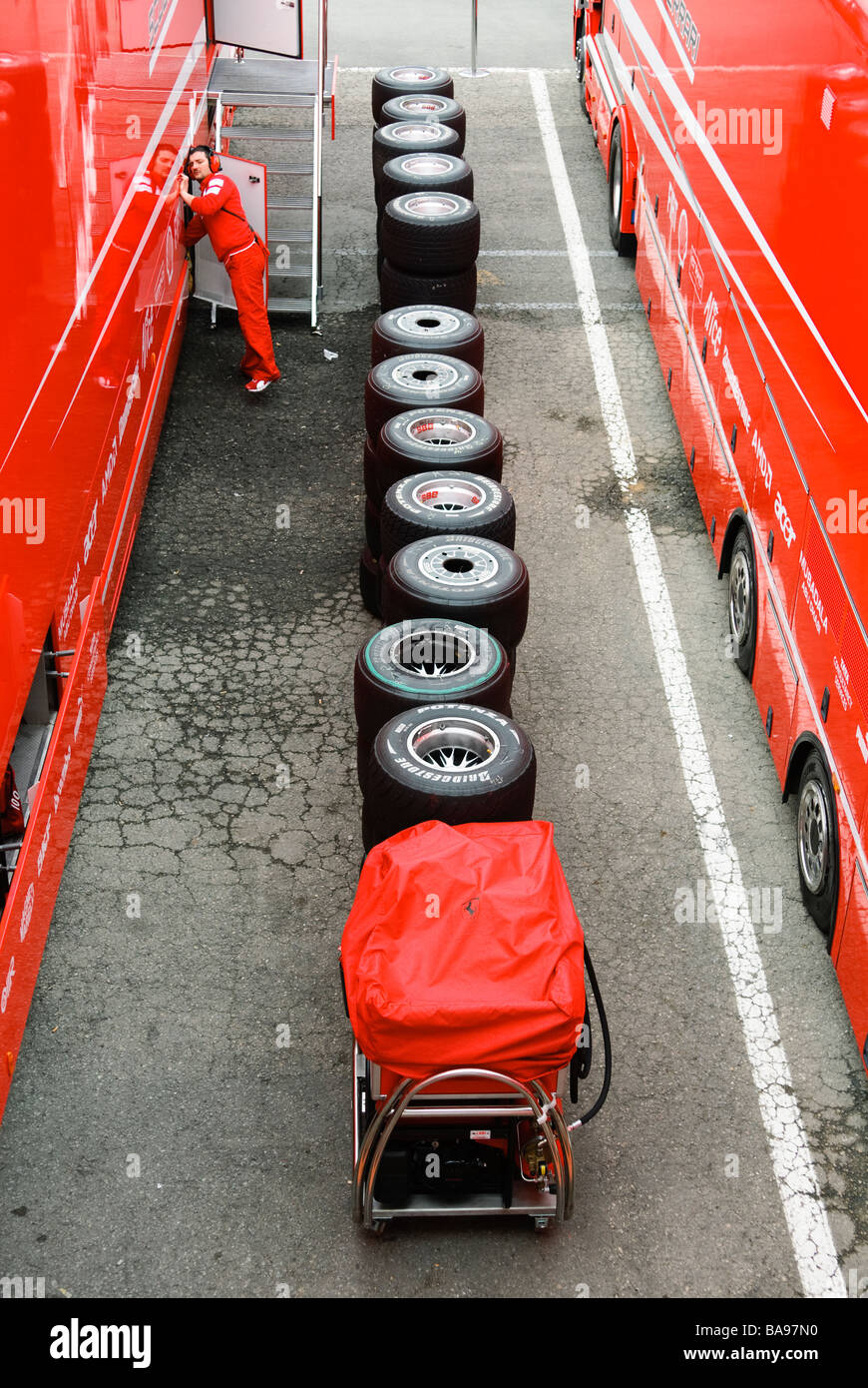 stacked slick racing tyres between Ferrari Formula One Trucks in the ...