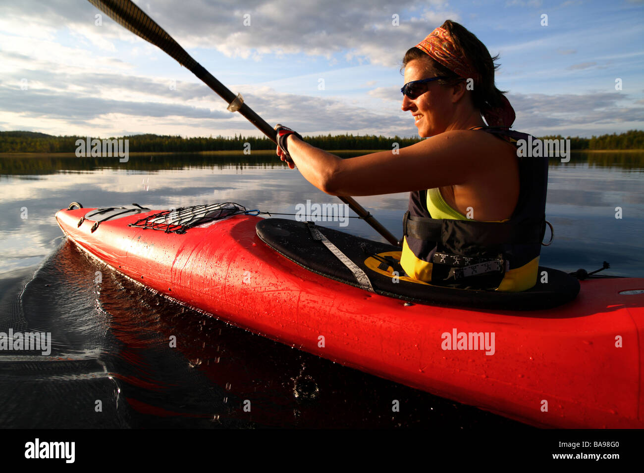 A woman canoeing Norrbotten Sweden Stock Photo - Alamy