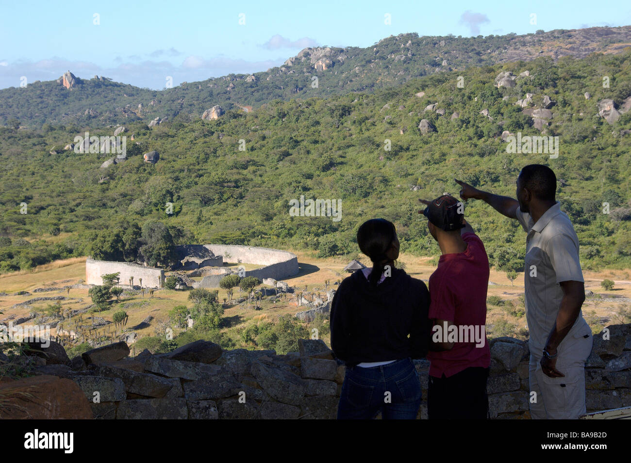 Tourists marvel at the size of Zimbabwe's Great Zimbabwe Ruins, the ...