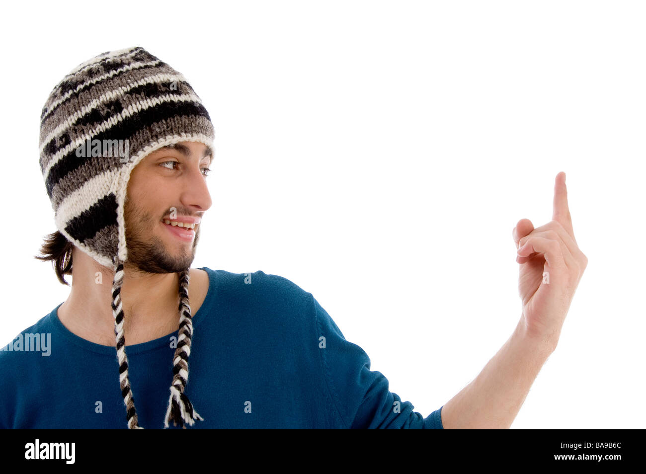young man in woolen cap pointing upwards Stock Photo - Alamy