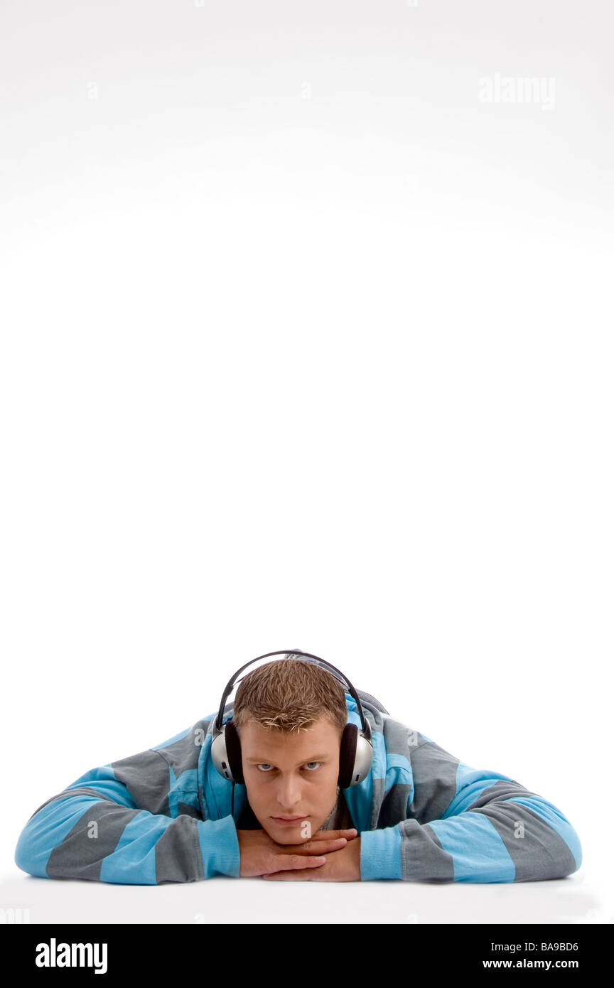 laying young man with headphone Stock Photo - Alamy
