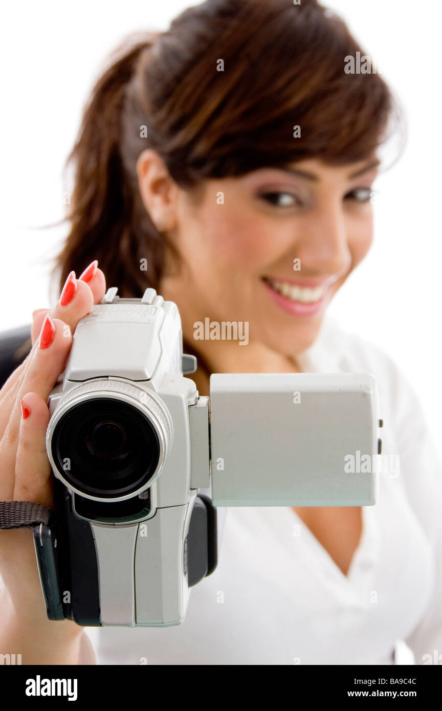 front view of smiling female shooting with handy camera Stock Photo - Alamy