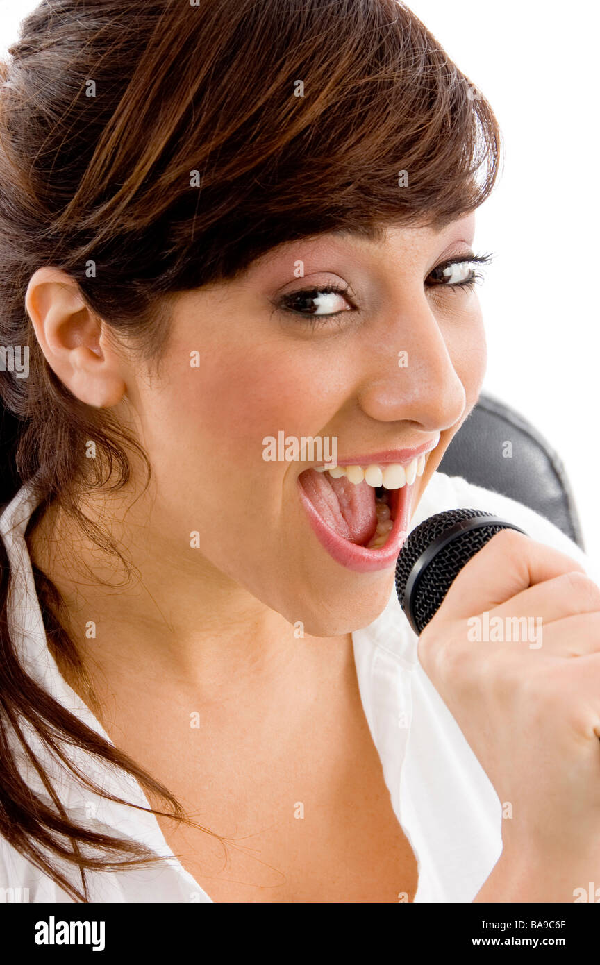 front view of smiling female singing on microphone Stock Photo - Alamy