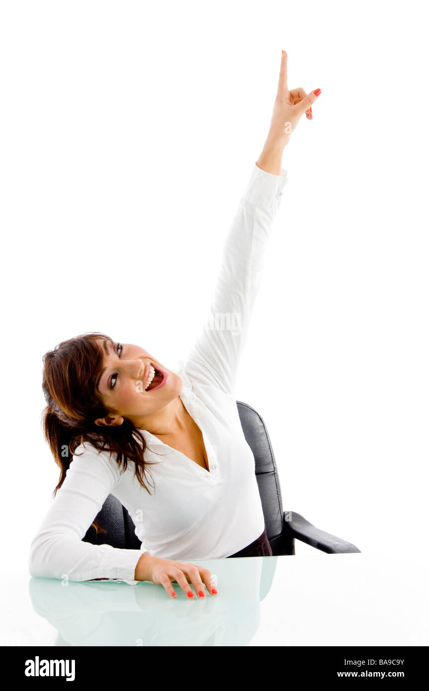 front view of smiling female pointing upwards Stock Photo - Alamy