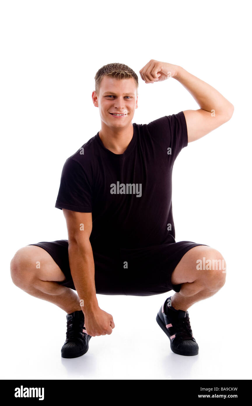 sitting muscular man showing his muscles Stock Photo - Alamy
