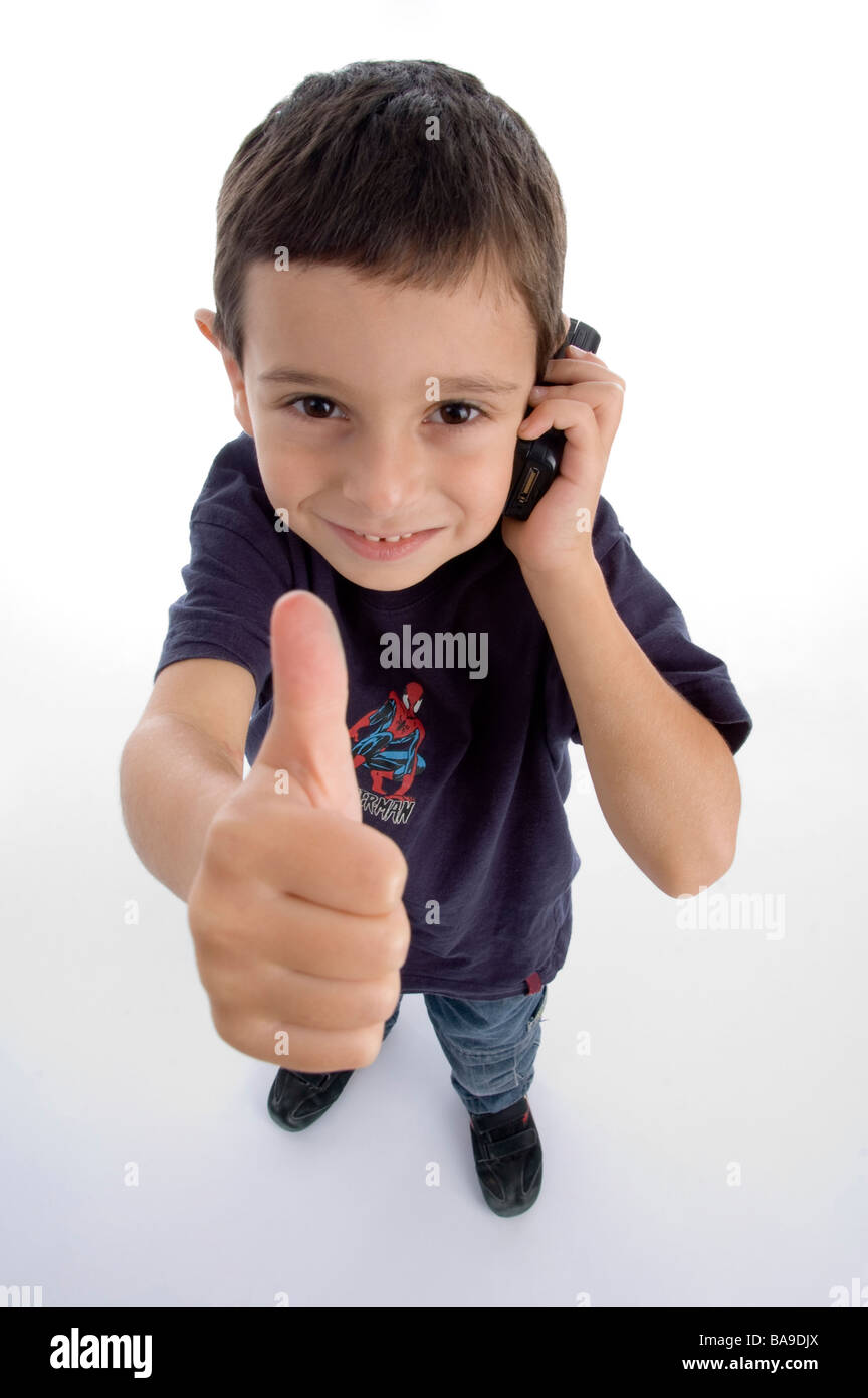 adorable boy busy on phone call and showing thumbs up Stock Photo - Alamy