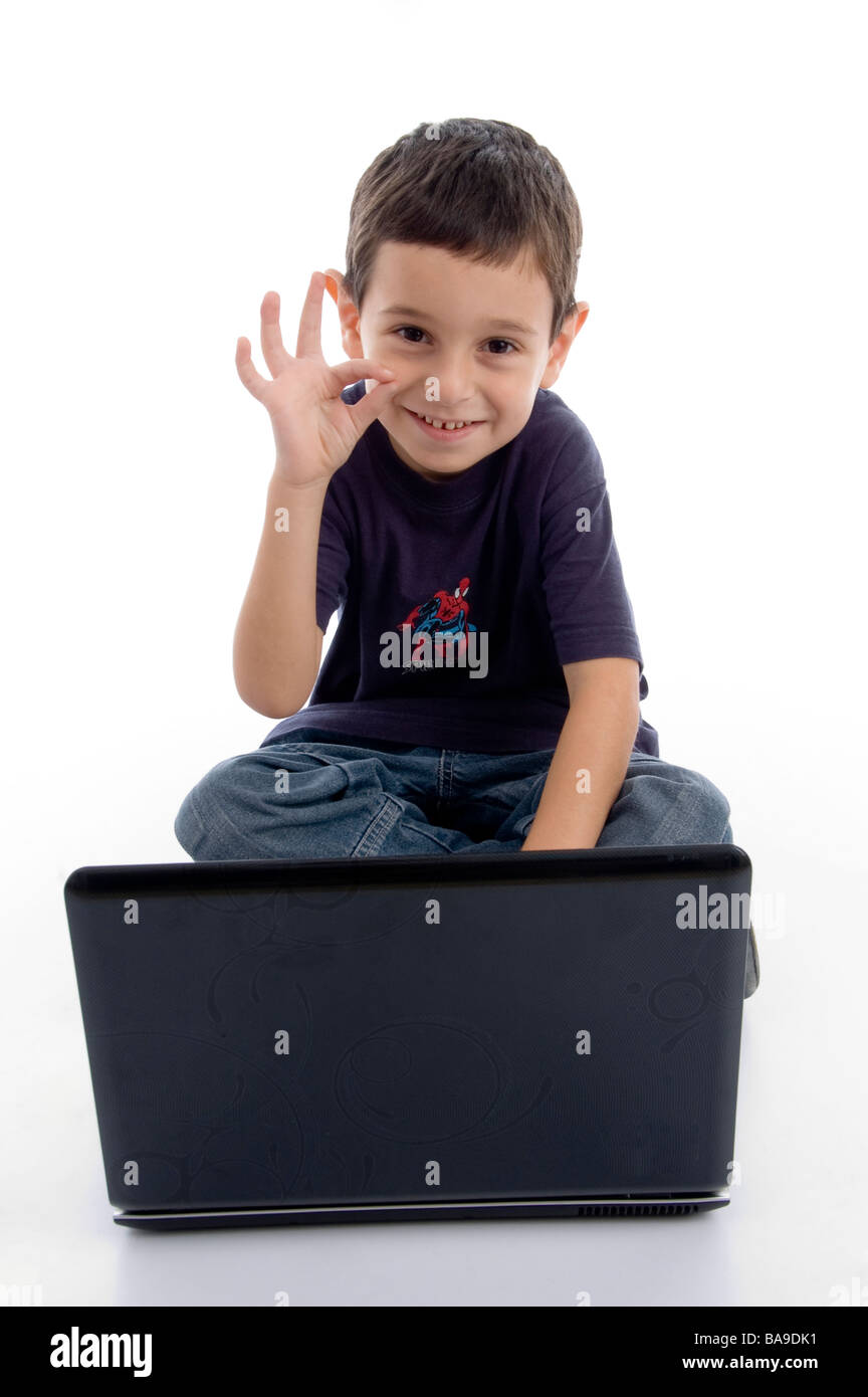 cute young boy with laptop showing okay hand gesture Stock Photo - Alamy