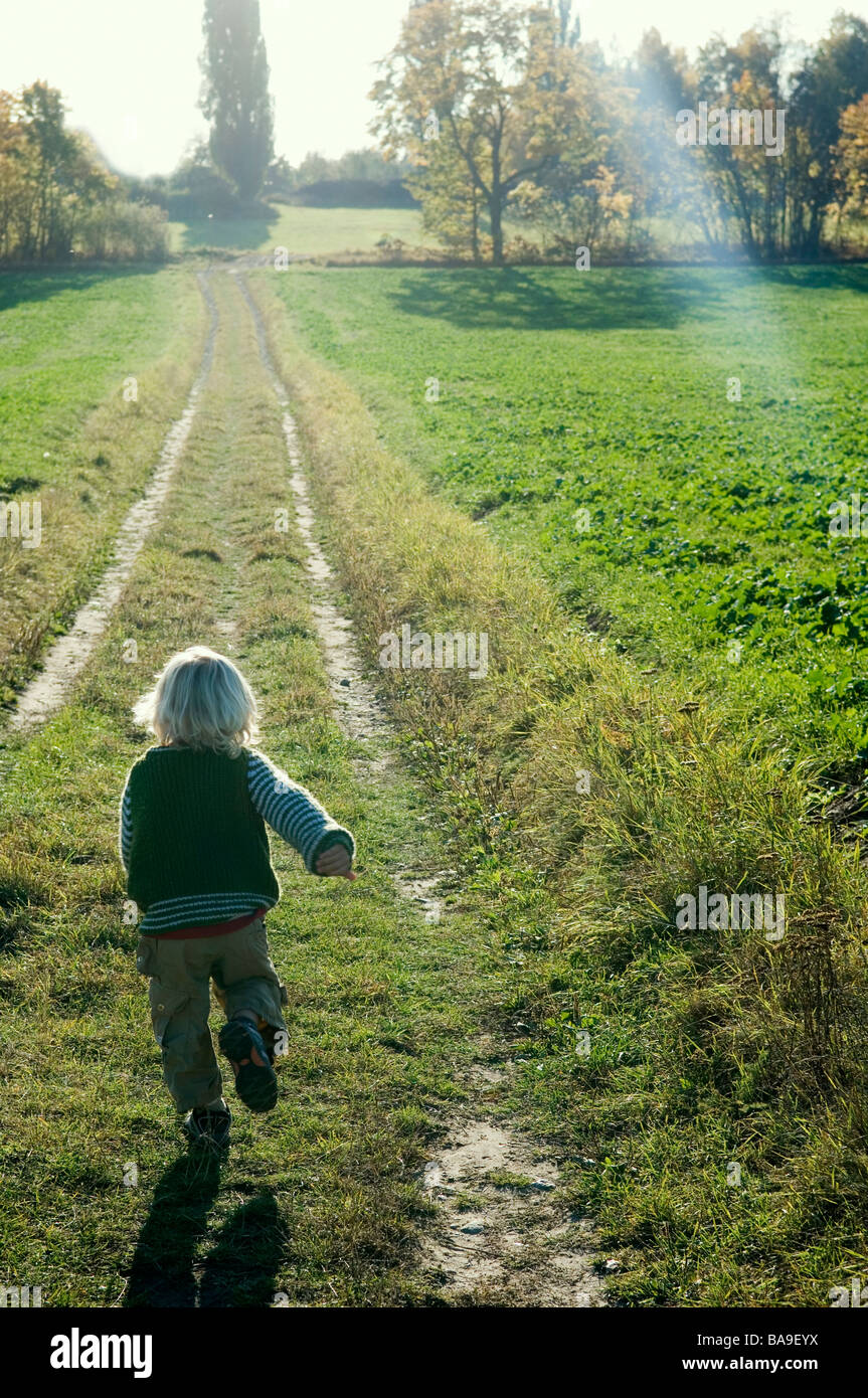 Child running on path rear view hi-res stock photography and images - Alamy